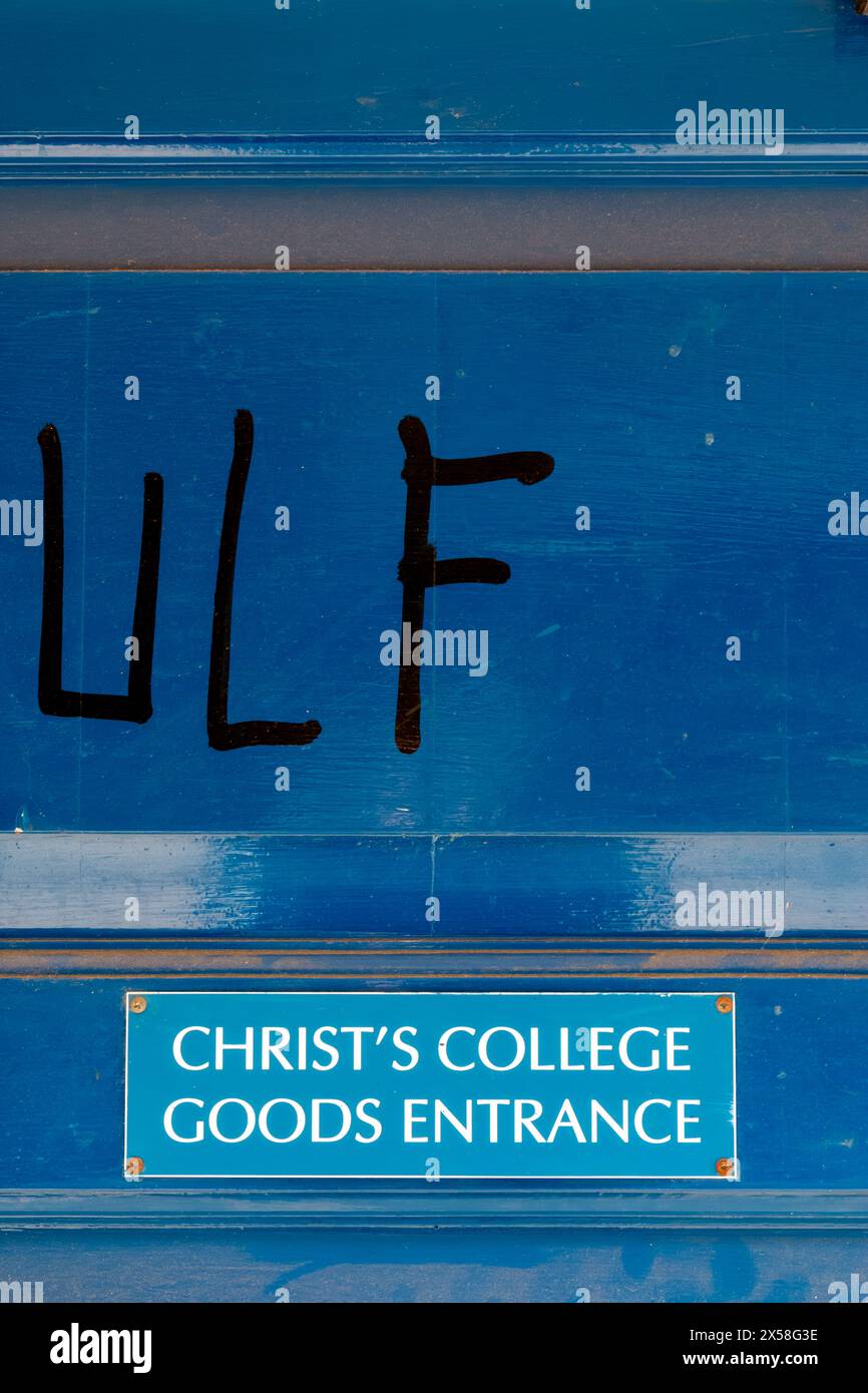 Signage reading 'CHRIST'S COLLEGE GOODS ENTRANCE' mounted on a blue ...