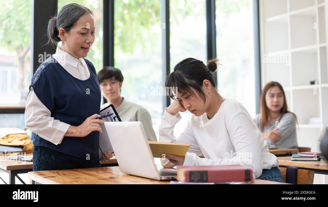 Young student struggle to understand the lesson while teacher trying to help her in the ...