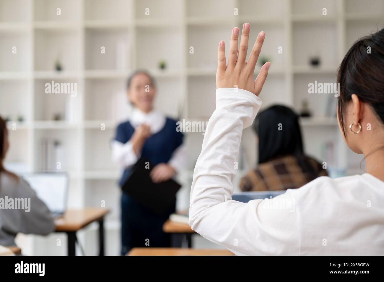 Child asking question raising hand hi-res stock photography and images ...