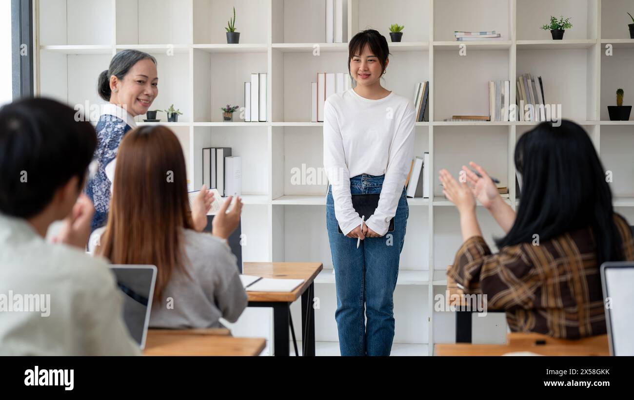 The teacher and everyone in the classroom is applauding a student who ...