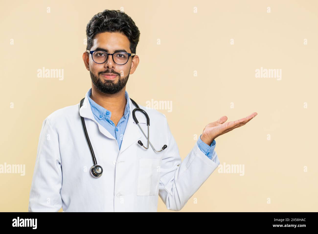 Indian young doctor cardiologist man show thumbs up and pointing right ...