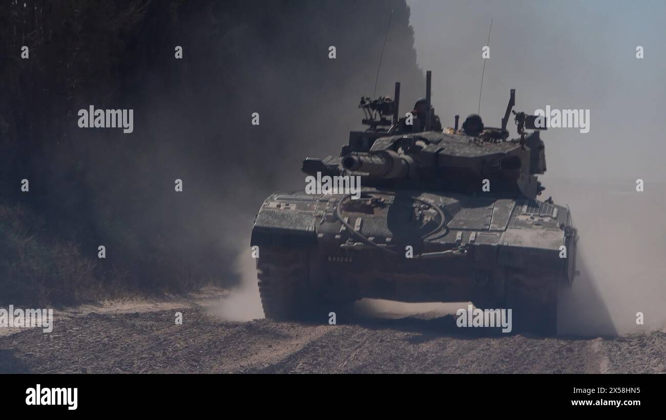 An Israeli Merkava tank rolls near the border with the southern Gaza ...