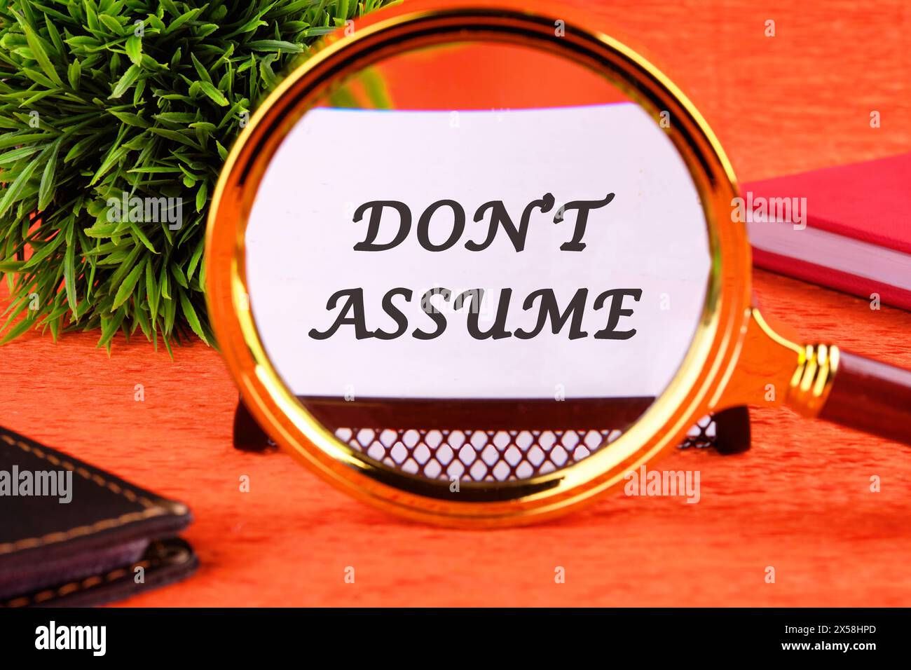 Financial concept meaning Don't Assume through a magnifying glass on a ...