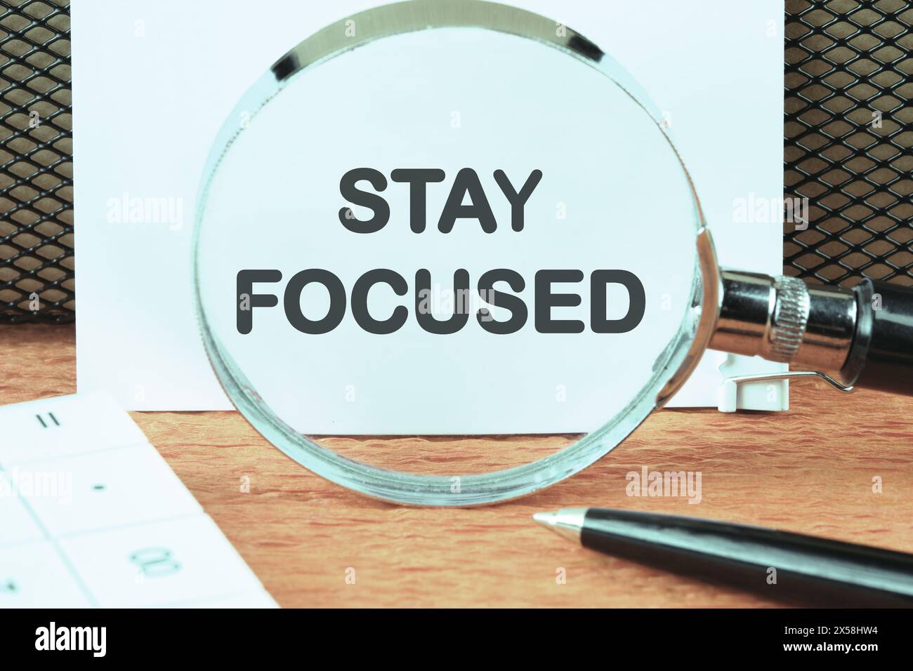 Concept words Stay focused written through a magnifying glass on a ...