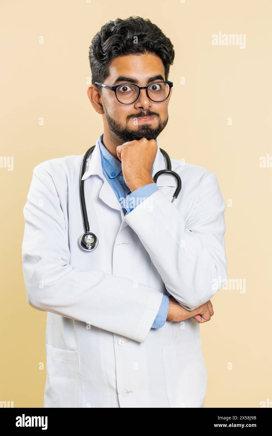 Sad Indian young doctor cardiologist man tired bored exhausted ...