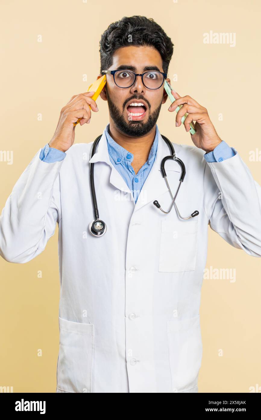 Irritated nervous stressed tired Indian doctor cardiologist man talking ...