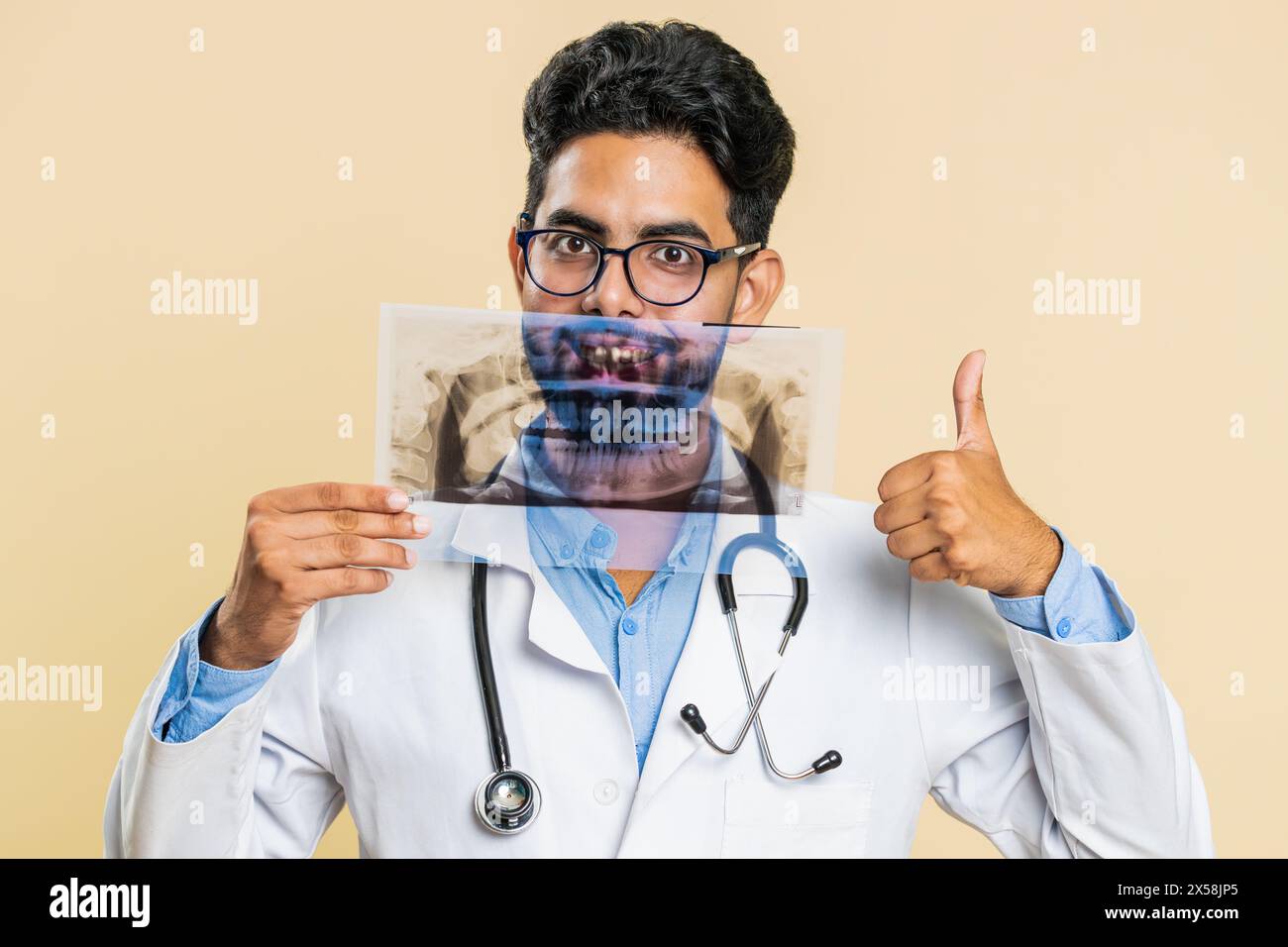 Indian young doctor orthodontist man examines a panoramic x-ray picture ...