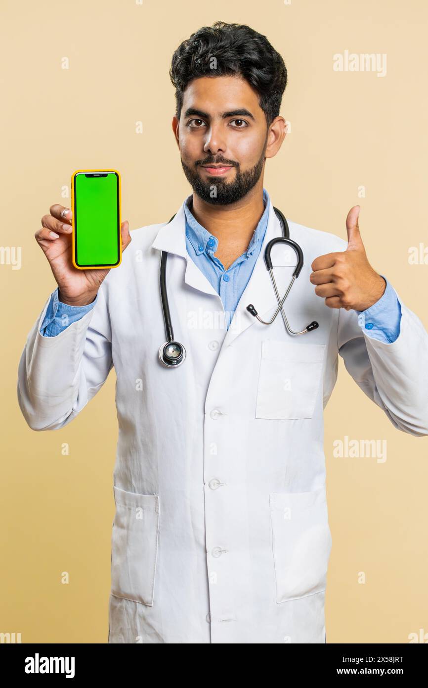 Indian doctor cardiologist man hold smartphone with green screen chroma ...