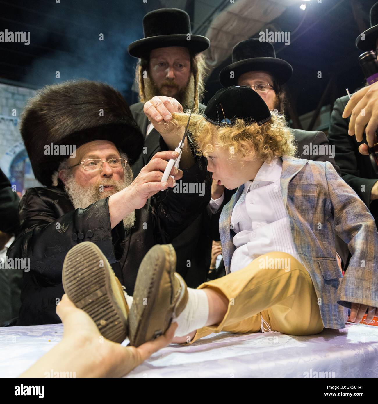 A three-year-old boy receives his first haircut, a traditional ritual ...