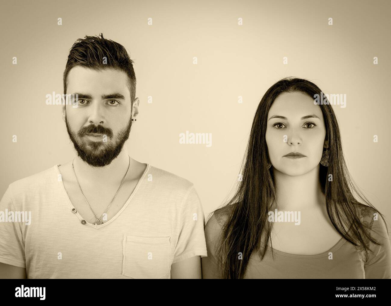 Man and woman pose with grave expressions, their serious demeanor ...