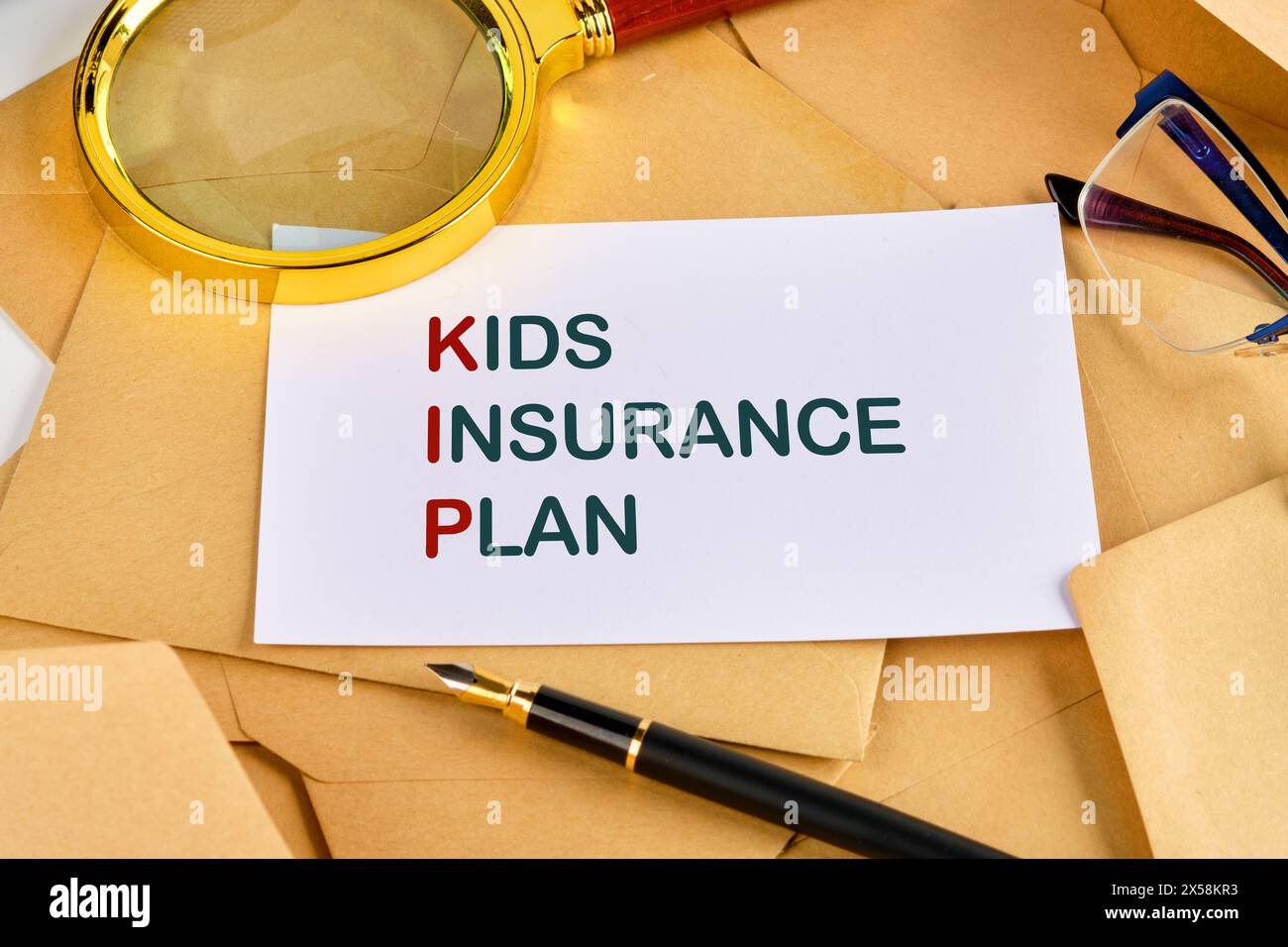 KIP kids insurance plan symbol on a blank sheet near a pen, magnifying ...