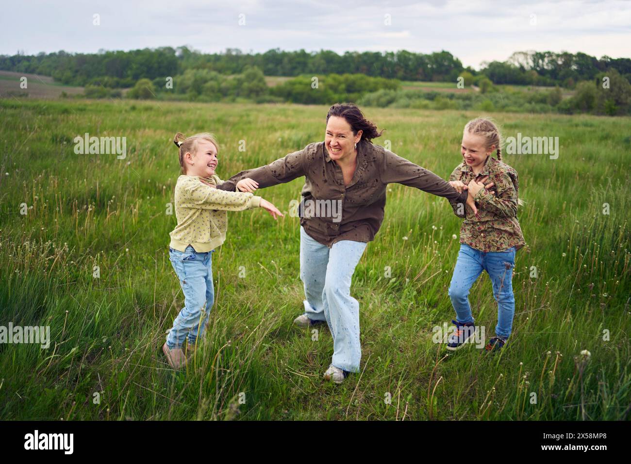a mother breaks up the children who are fighting in the rain in the ...