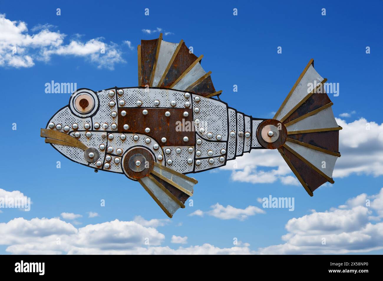 Metal fish flies in the clouds Stock Photo - Alamy