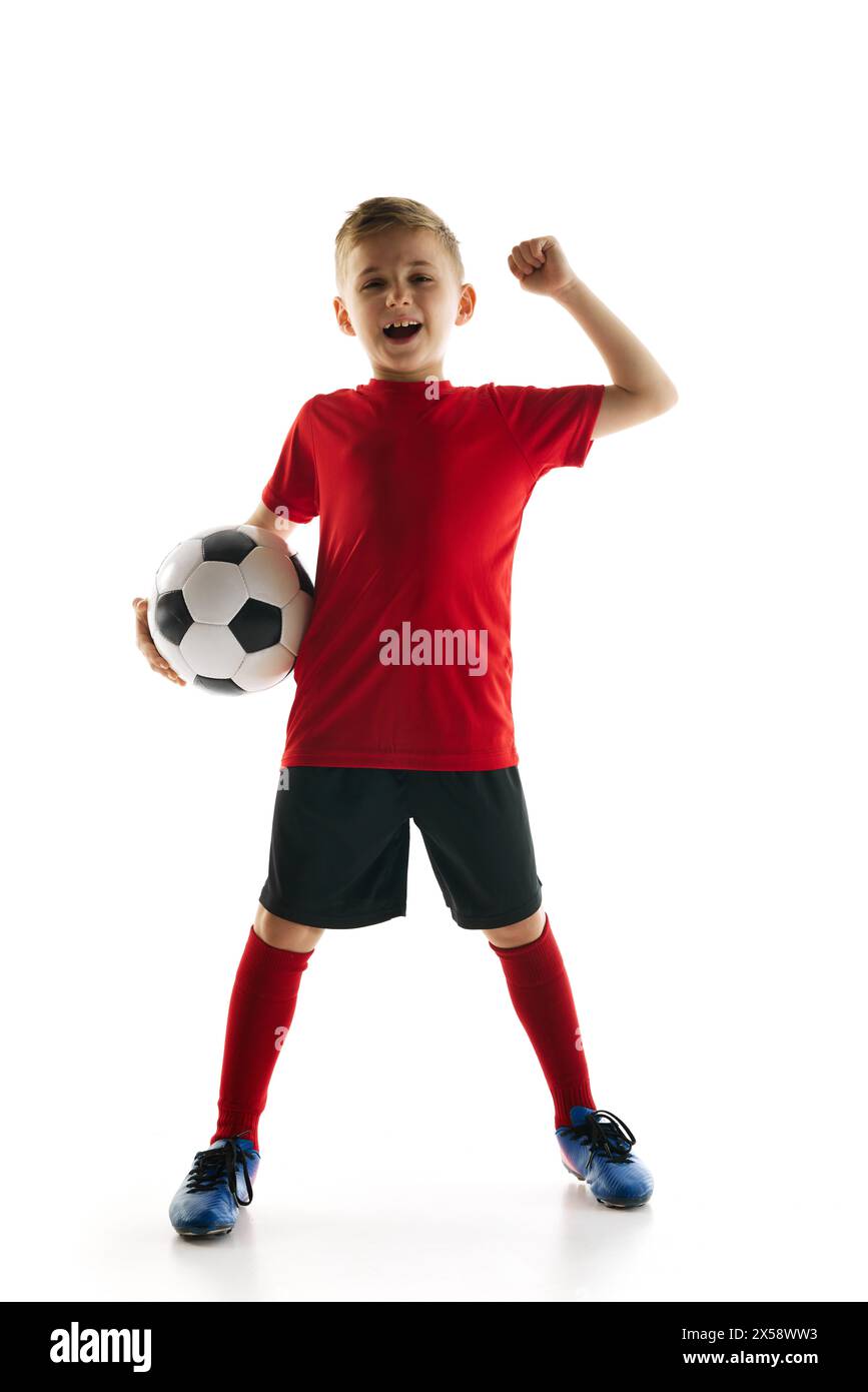 Victory. Goal. Young boy as soccer player in sportwear clenched fist ...