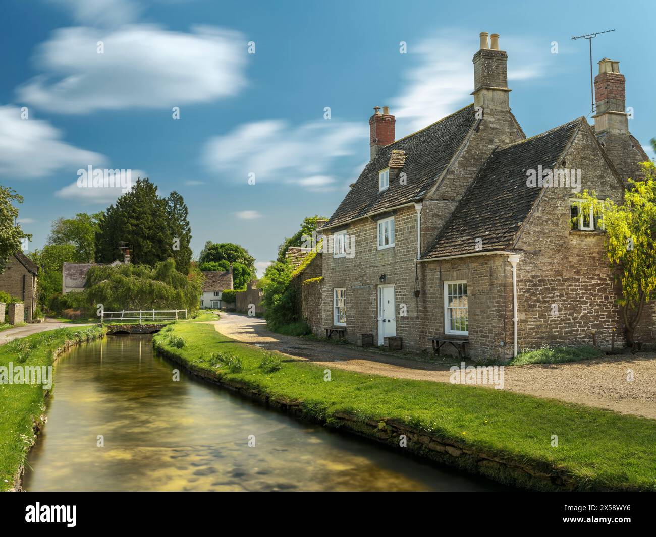 The River Thames entering the picturesque Wiltshire village of Ashton ...
