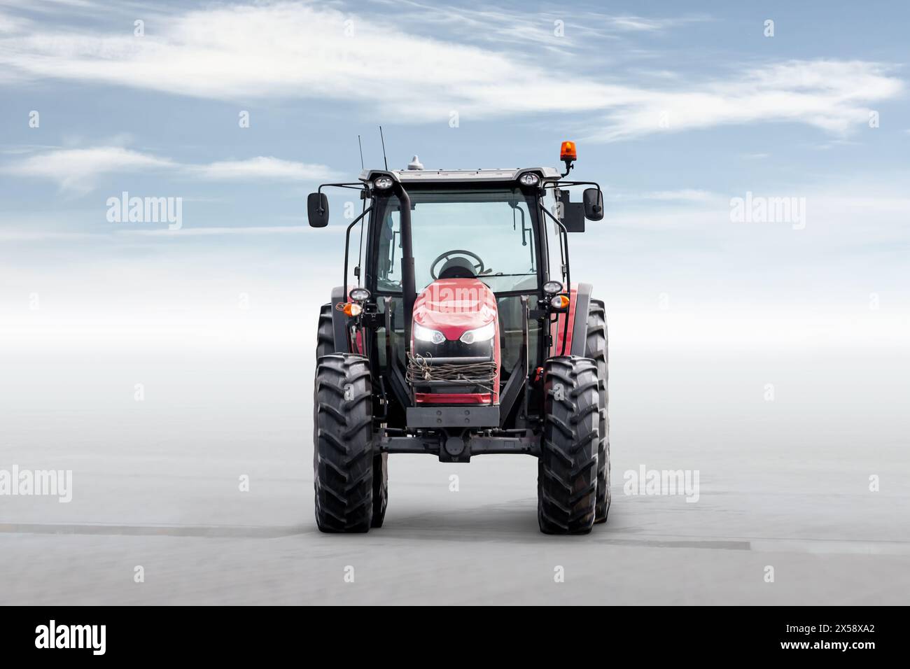 Front view of the red modern wheeled tractor isolated on bright ...