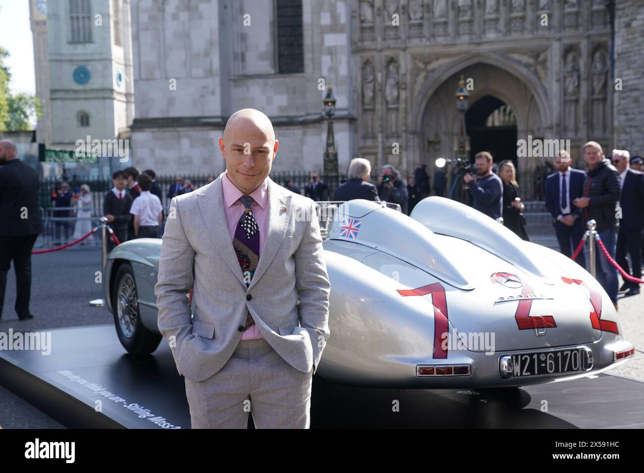Elliot Moss poses in front of the Mercedes-Benz 300 SLR 722 on display ...