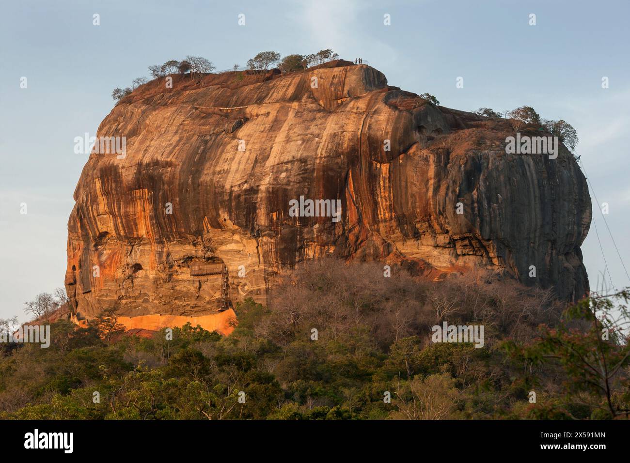 The sun sets over Sigiriya Rock Fortress in central Sri Lanka.The rock ...