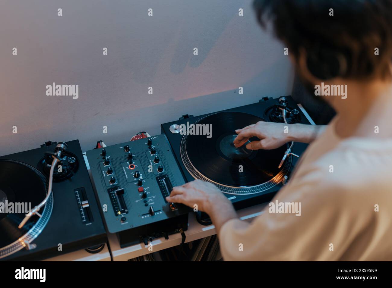 Dj mixing music on turntables at a nightclub event Stock Photo - Alamy