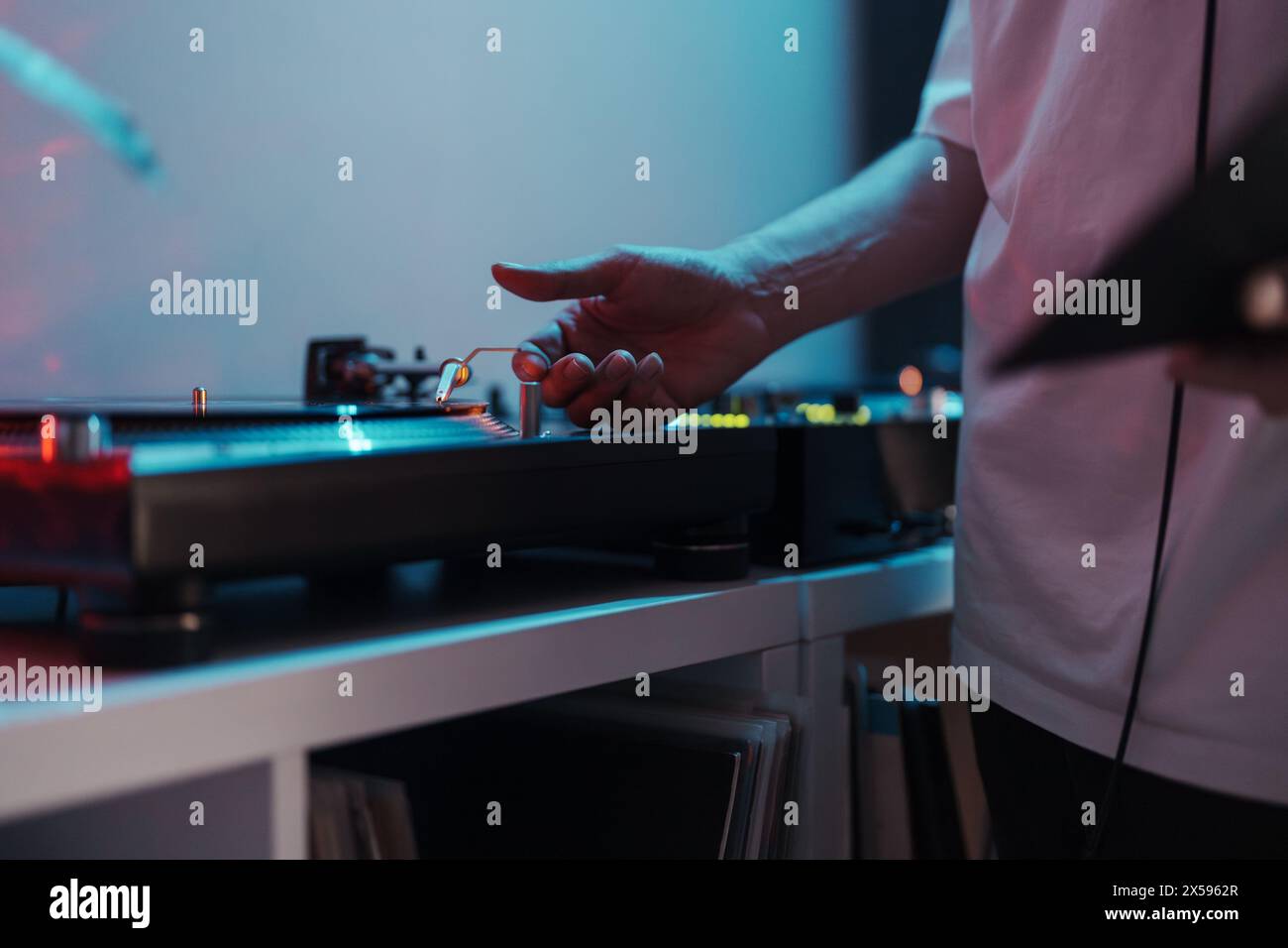 Dj in action playing vinyl record at club party Stock Photo - Alamy