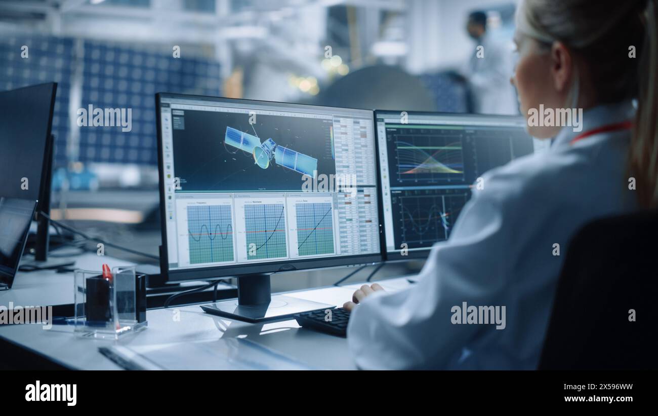 Female Engineer Uses Computer To Analyse Satellite Calculate Orbital