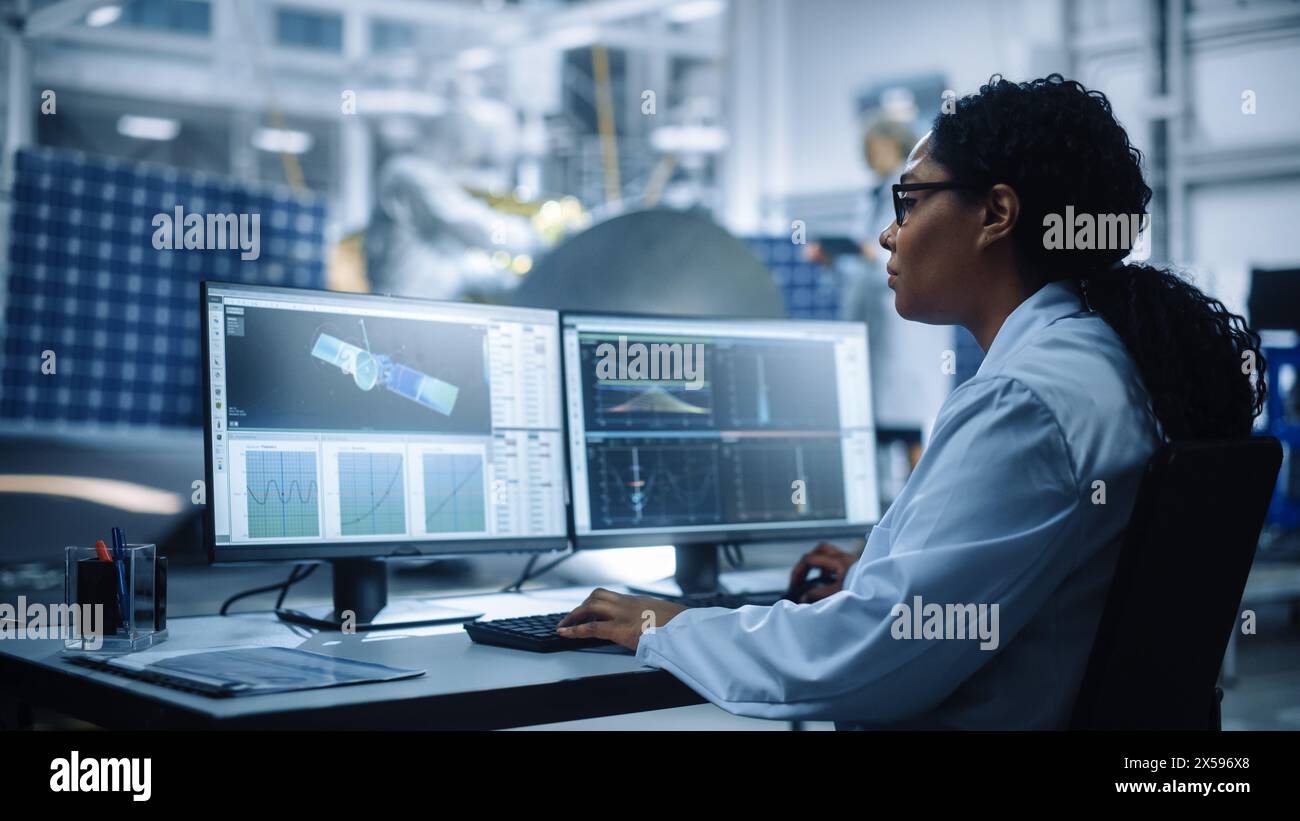 Female Engineer uses Computer to Analyse Satellite, Calculate Orbital ...