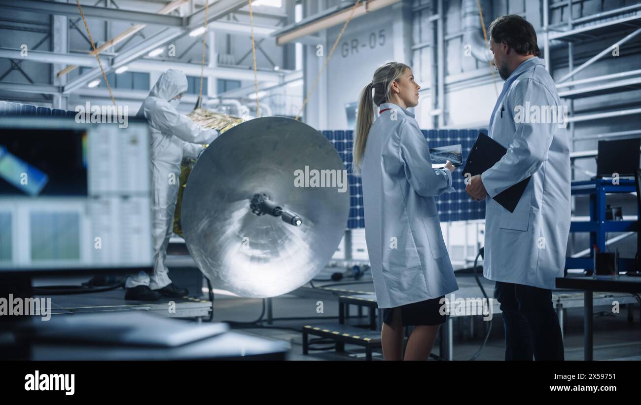 Engineer and Technician Talk, Use Tablet Computer while Working on ...