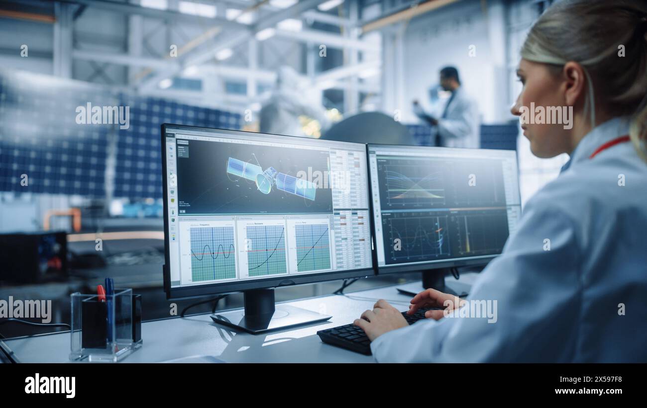 Female Engineer Uses Computer To Analyse Satellite Calculate Orbital Trajectory Tracking