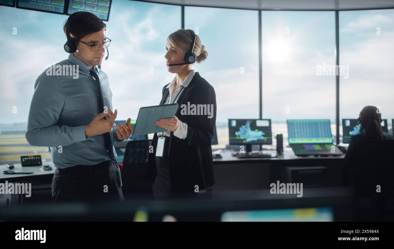 Female and Male Air Traffic Controllers with Headsets Talk in Airport ...