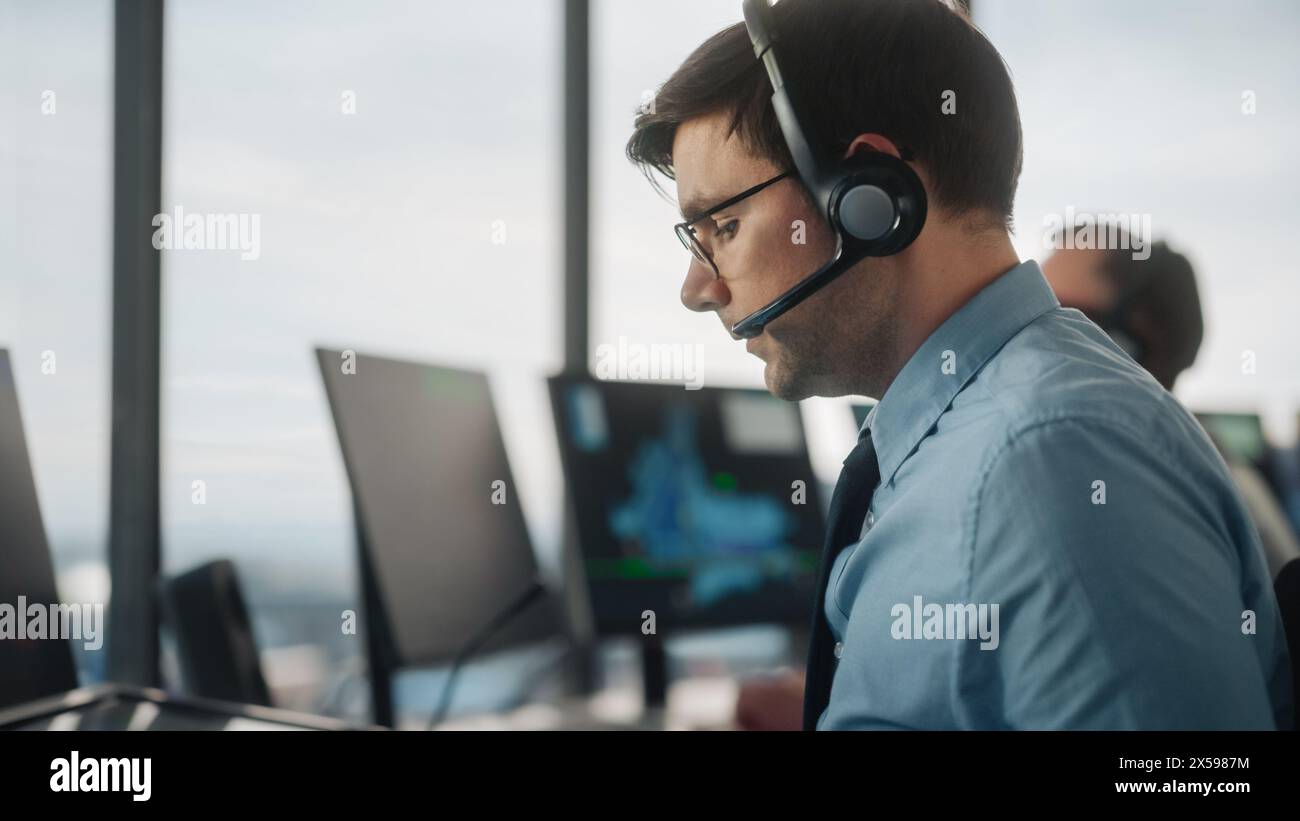 Male Air Traffic Controller with Headset Using Touchscreen Table Panel ...
