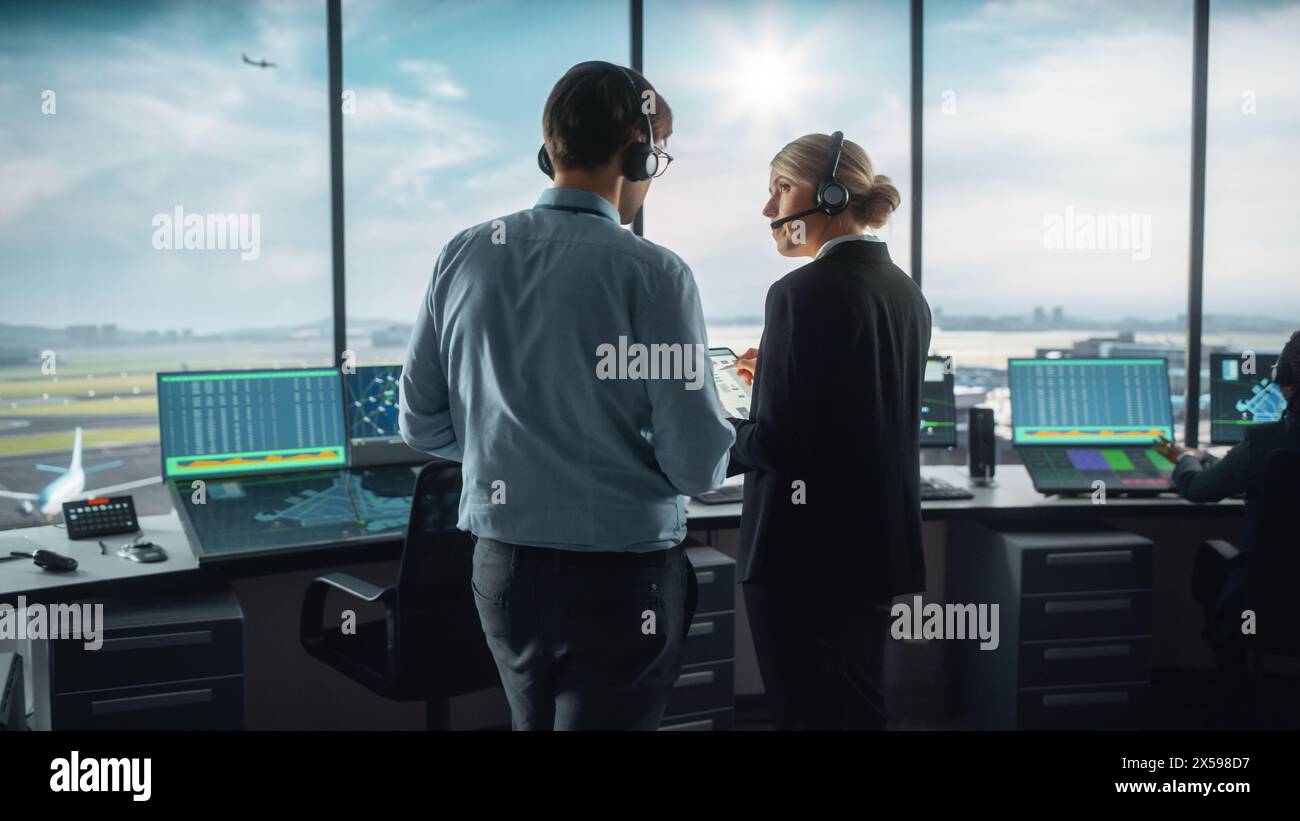 Female and Male Air Traffic Controllers with Headsets Talk in Airport ...