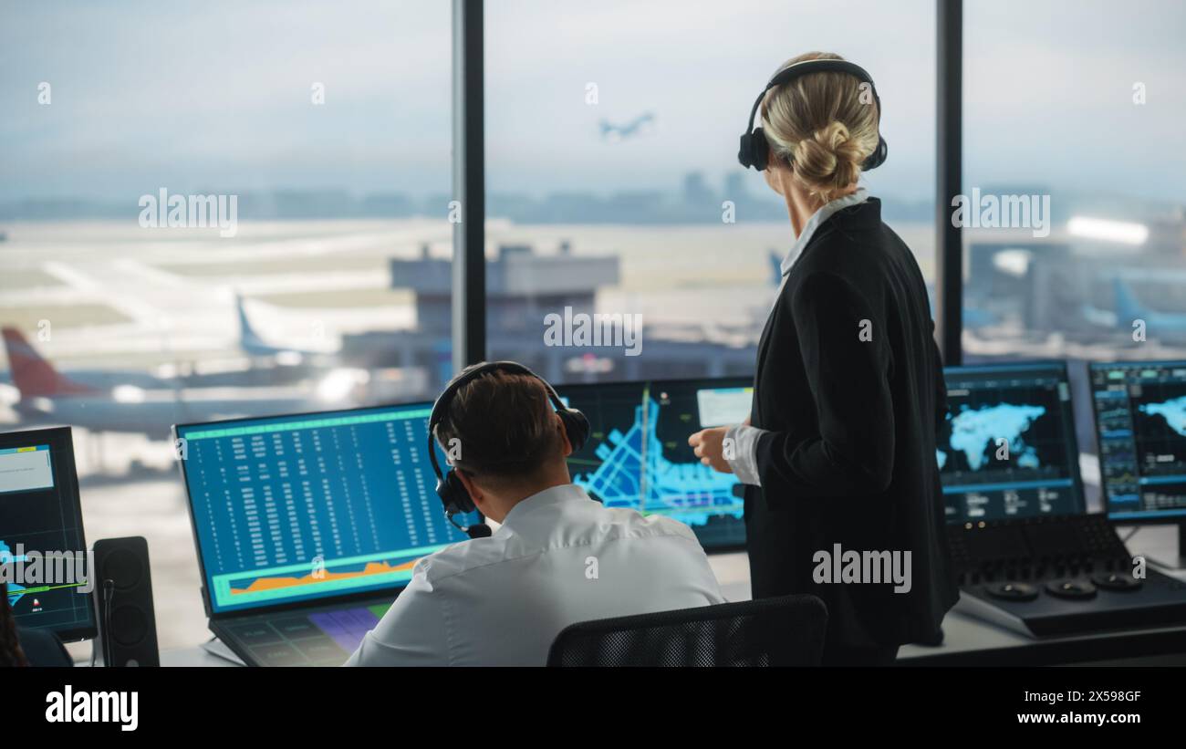 Female and Male Air Traffic Controllers with Headsets Talk in Airport ...