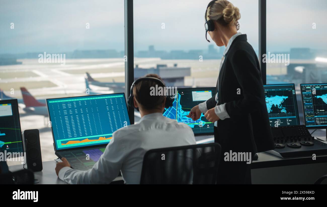 Female and Male Air Traffic Controllers with Headsets Talk in Airport ...