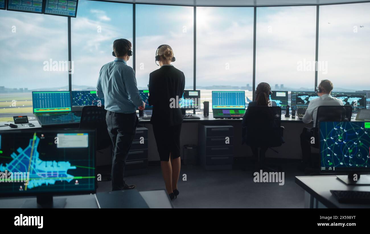 Female and Male Air Traffic Controllers with Headsets Talk in Airport ...