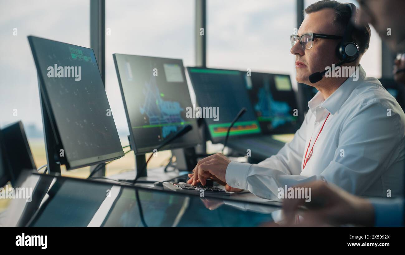 Male Air Traffic Controller with Headset Using Touchscreen Table Panel ...