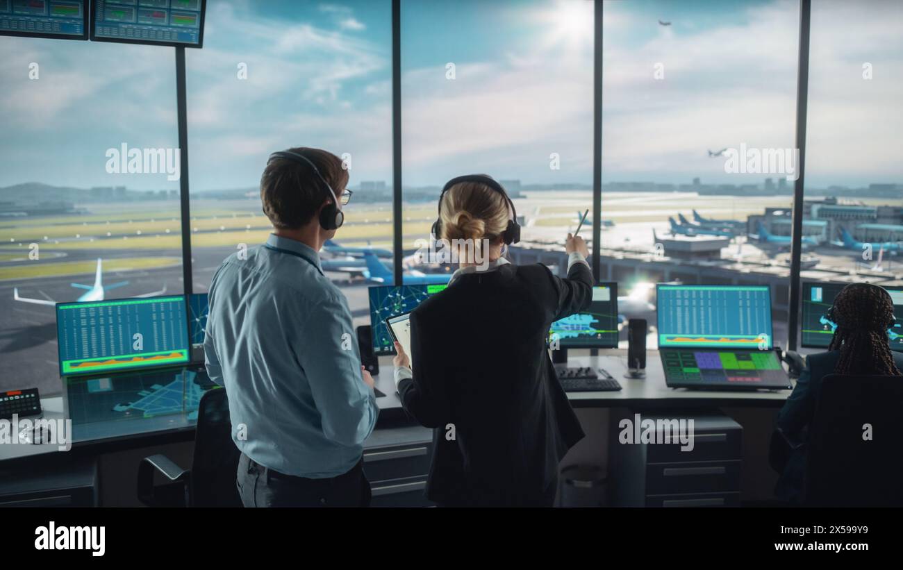 Female and Male Air Traffic Controllers with Headsets Talk in Airport ...