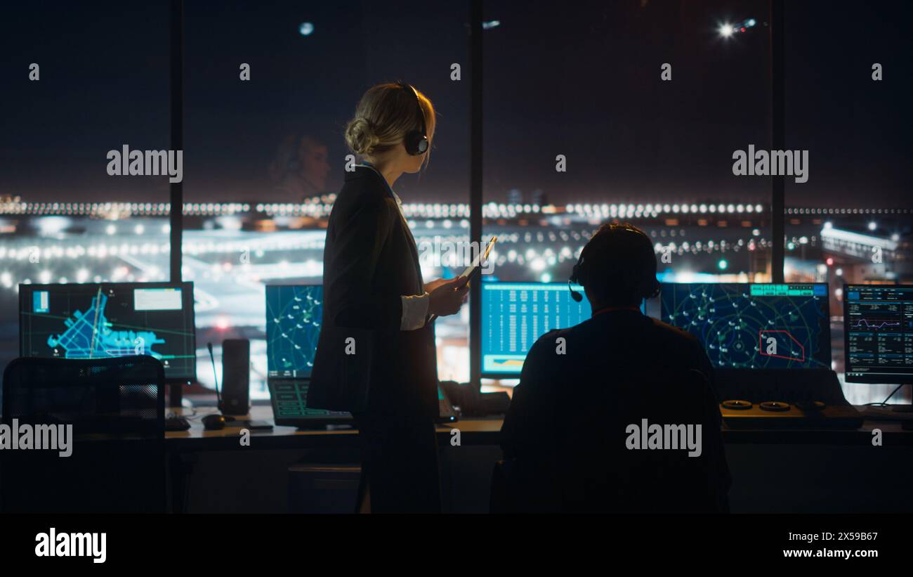 Female and Male Air Traffic Controllers with Headsets Talk in Airport ...