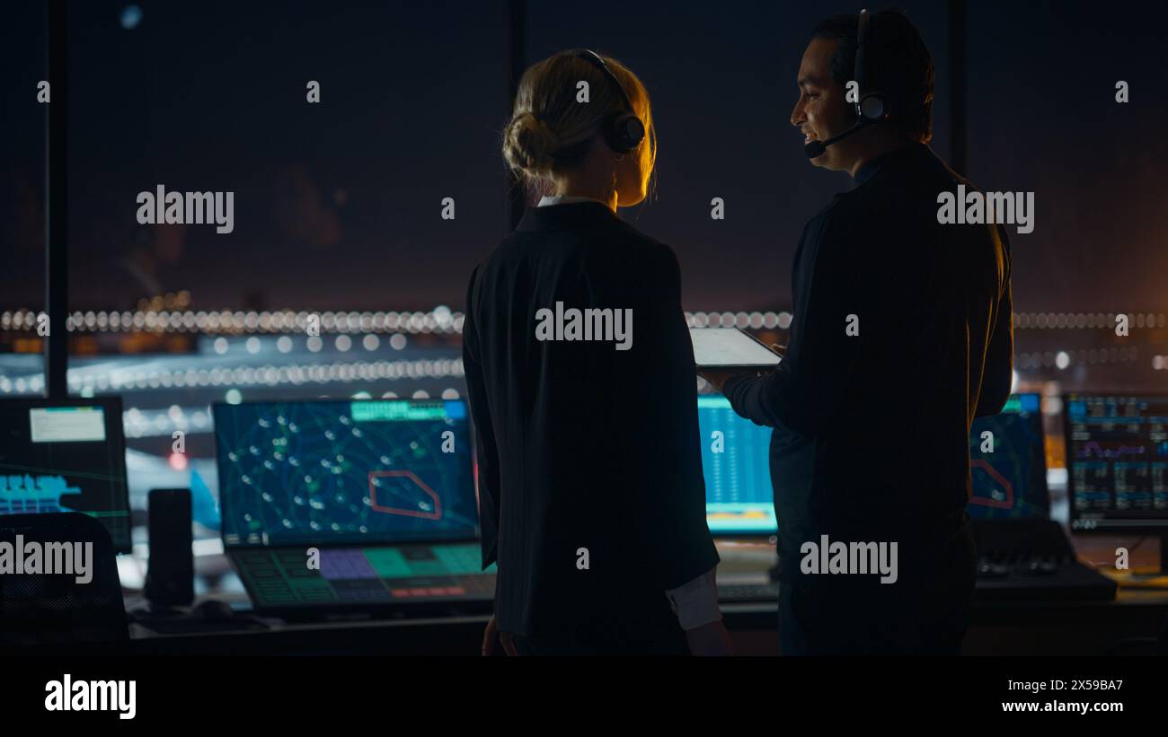 Female and Male Air Traffic Controllers with Headsets Talk in Airport ...