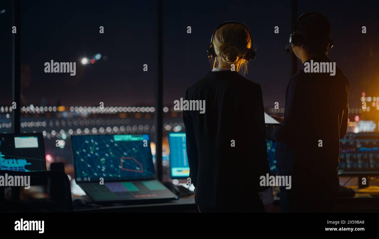 Female and Male Air Traffic Controllers with Headsets Talk in Airport ...