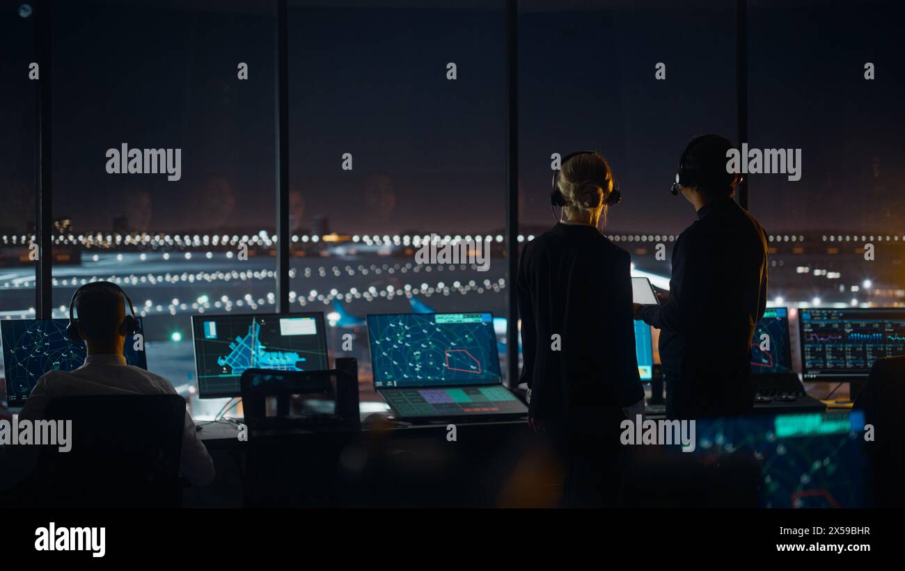 Female and Male Air Traffic Controllers with Headsets Talk in Airport ...