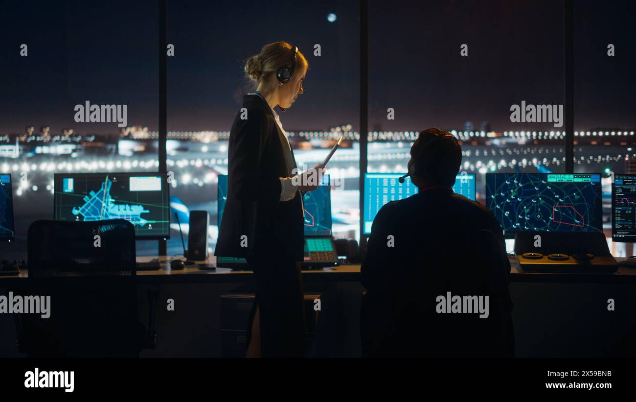 Female and Male Air Traffic Controllers with Headsets Talk in Airport ...