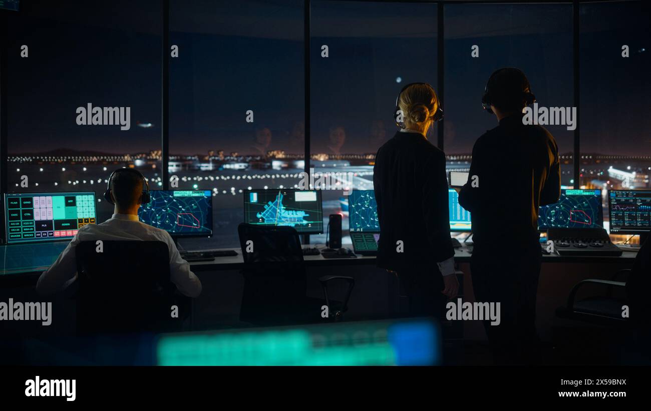 Female and Male Air Traffic Controllers with Headsets Talk in Airport ...