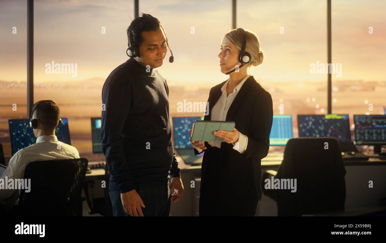 Female and Male Air Traffic Controllers with Headsets Talk in Airport ...