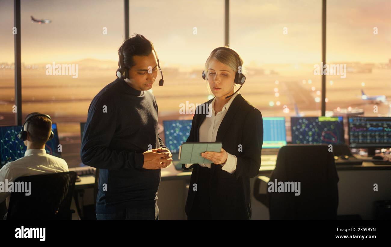 Female and Male Air Traffic Controllers with Headsets Talk in Airport ...