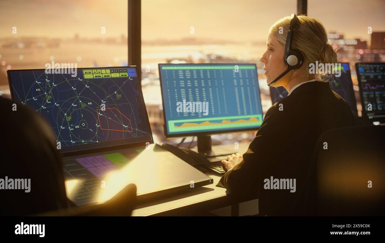 Female Air Traffic Controller with Headsets Talk in Airport Tower. Office Room Full of Desktop ...