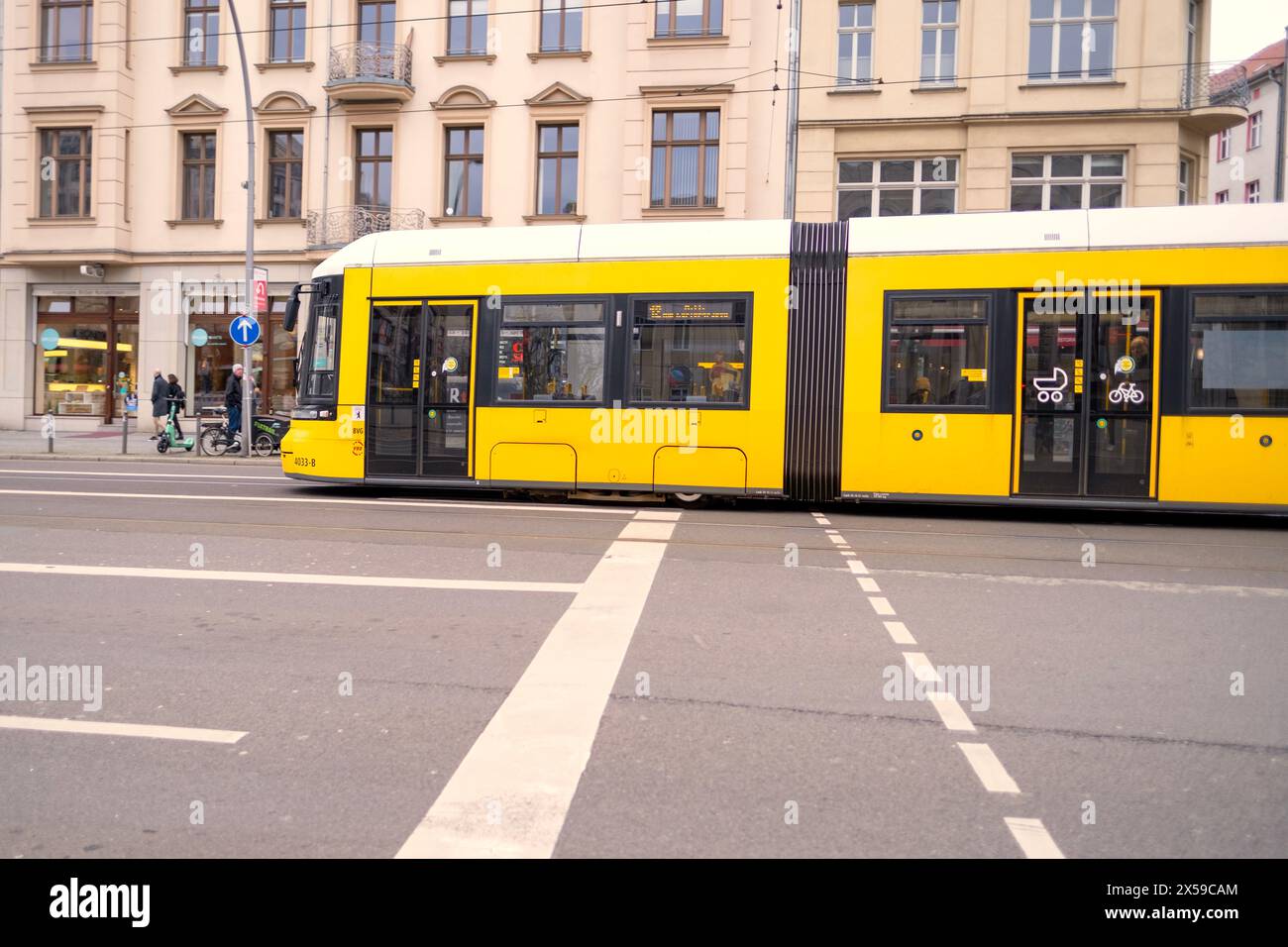yellow tram driving down city street in Berlin, travel, tourism and ...