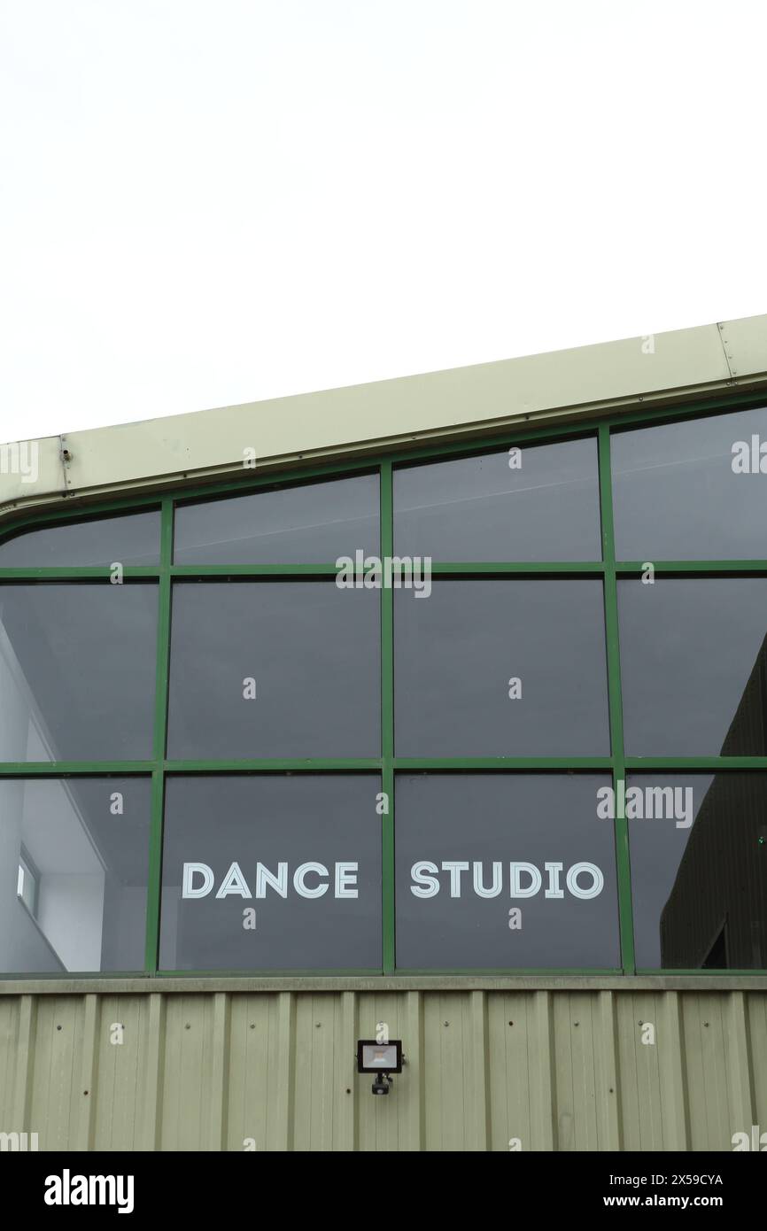 Dance studio sign on window of modern building with large windows Stock ...