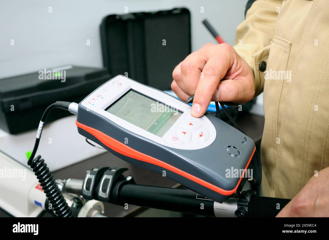 Radiation detector testing. Dosimetrist hands adjusting a portable ...