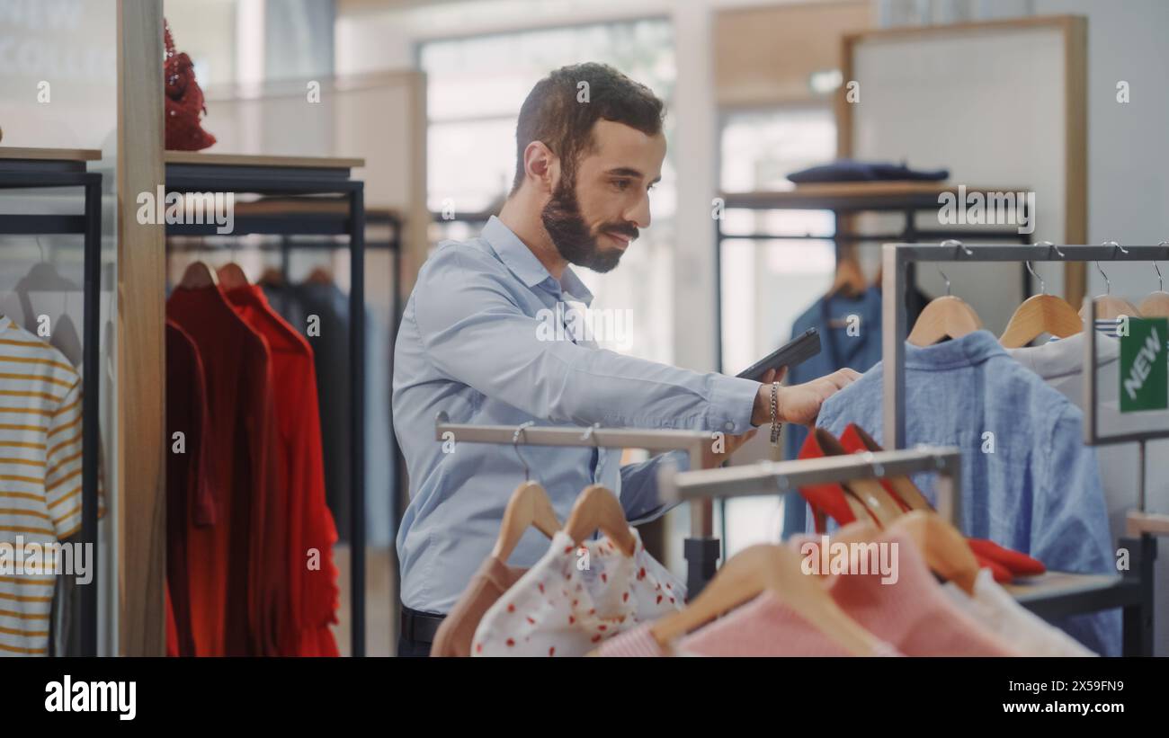 Clothing Store: Male Visual Merchandising Professional Uses Tablet ...