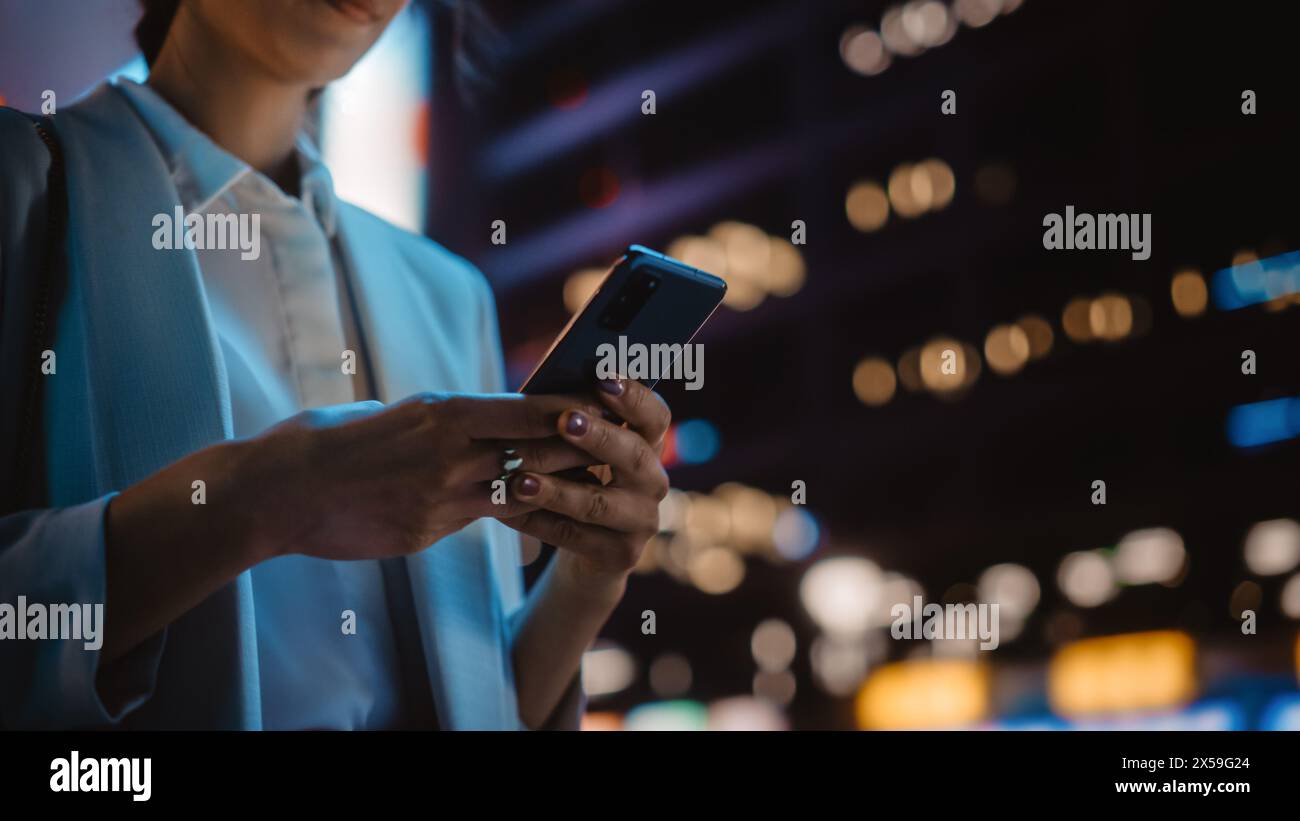 Focus on Female Hand Using Smartphone Walking Through Night City Street ...
